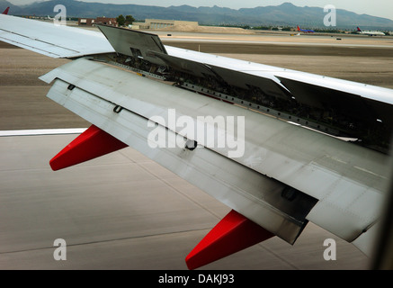 aircraft wing spoiler deployed during landing showing hydraulics Stock ...