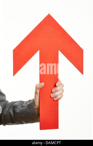 Businesswoman holding big red arrow symbol sign to the right in front ...