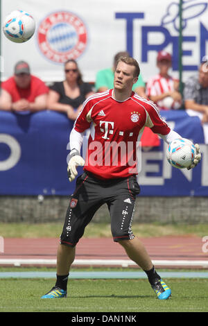Bayern goalkeeper Manuel Neuer throws a training pole during a practice ...