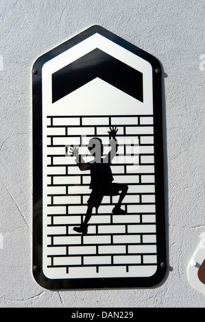 man climbing up a brick wall Stock Photo - Alamy
