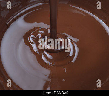 Yummy melted chocolate splash with falling pieces on white background ...