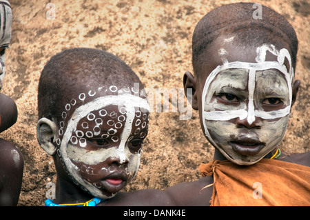 Suri (Surma) kids with painted faces on a rock, Ethiopia Stock Photo ...