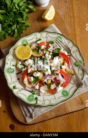 eating a Greek salad with feta cheese and pieces of dried rye bread ...
