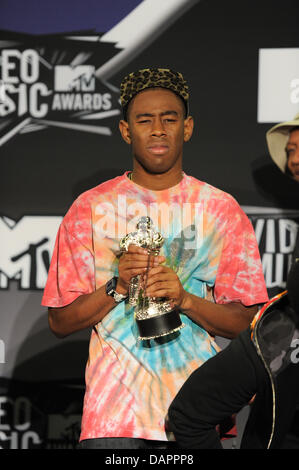 Tyler, The Creator poses in the press room with the award for best rap ...