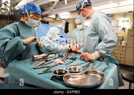 Army doctors of the German Bundeswehr treat a small Afghan girl, who ...