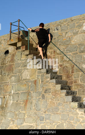 Woman Climbs Up Stone Steps Carved Out of Rock Cliff in Mesa Verde ...