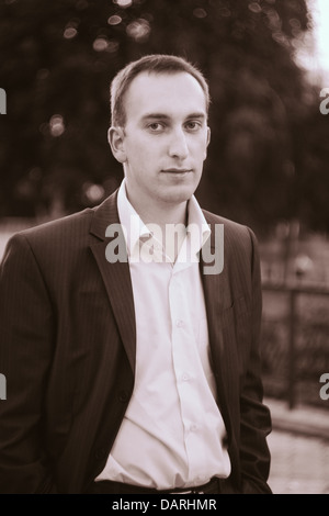 Picture of a serious business man posing isolated over grey wall ...