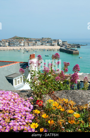 Looking down on St. Ives Cornish seaside town buildings, harbour boats ...