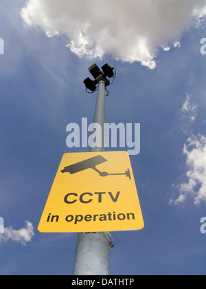 Blue surveillance camera security sign on stone wall in residential ...