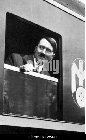 Adolf Hitler (1889-1945) looking out of the bars on the window to his ...