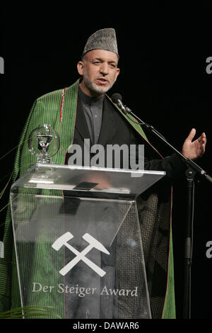 Afghan President Hamid Karzai holds the Holy Koran as he is sworn in as ...
