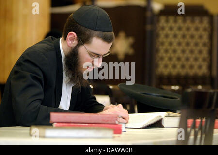 A student and prospective rabbi reads at the Jeschiwa Talmud university ...