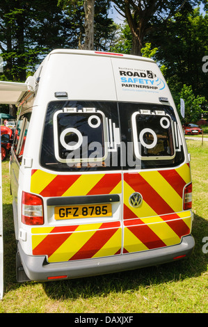 Traffic police officer with mobile speed camera on tripod checking ...