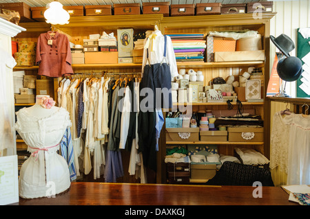 Old fashioned Victorian drapers shop with fabric and clothes on sale ...