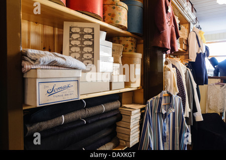 Old fashioned Victorian drapers shop with fabric and clothes on sale at ...