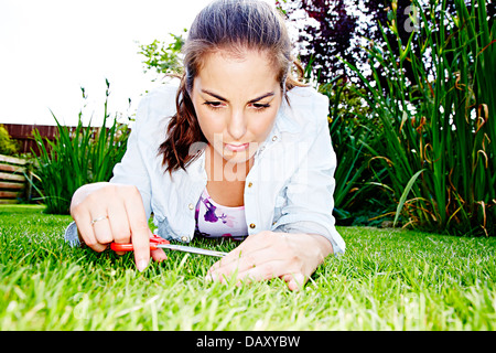 Cutting grass with a pair of scissors Stock Photo - Alamy