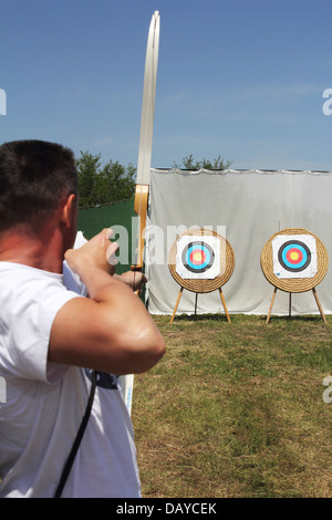 Outdoor archery targets on grass field surrounded by forest in the ...