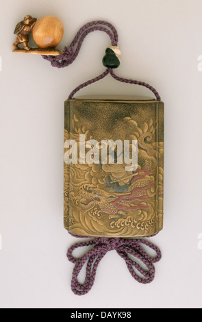 This set includes an inro, ojime, and netsuke, which are traditional ...