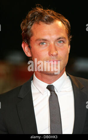 British actor Jude Law smiles for the cameras as he arrives for the ...