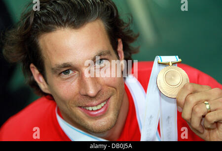 German Danny Ecker poses with his bronze medal won in the Pole Vault ...