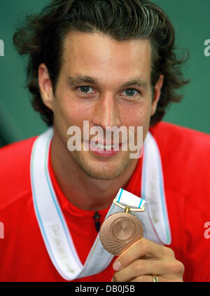 German Danny Ecker poses with his bronze medal won in the Pole Vault ...