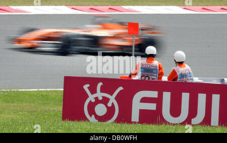 German Formula One rookie Adrian Sutil (L) of Spyker F1 Team and his ...
