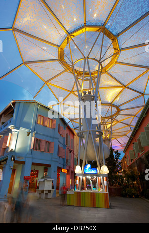A narrow city street illuminated by vibrant colorful light projections ...