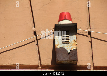 old security alarm system outside shop property in sun Stock Photo - Alamy