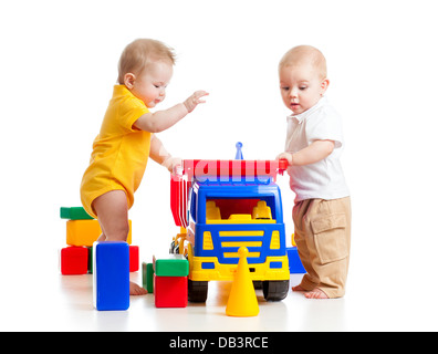 Group of two funny kids playing together outside, little boy and girl ...