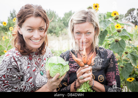 Abigail Sullivan and Kasha Rigby with some vegitables from their garden ...