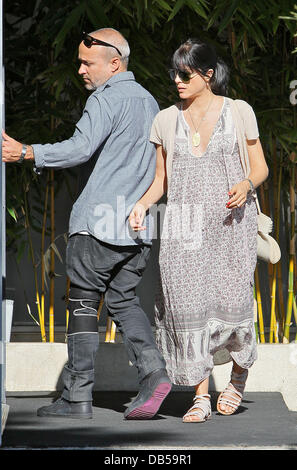 Heavily pregnant Selma Blair in a floral-print dress and sandals with ...