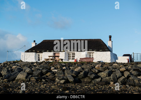 Thatched roof traditional blackhouse now used as youth hostel, Berneray ...