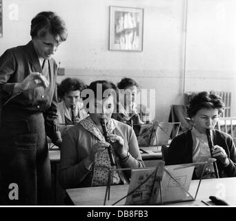 School music teacher plays the flute in the classroom. Woman teaches ...