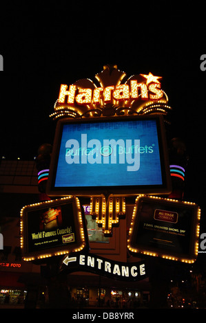 Night portrait neon Harrah's Sign with billboards advertising shows ...