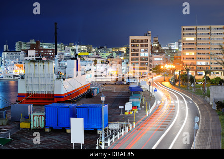 Naha, Okinawa, Japan industrial cityscape along Tomari Port at twilight ...