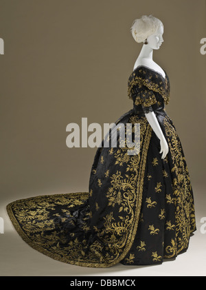 This woman's dress showcases traditional textile art, featuring ...