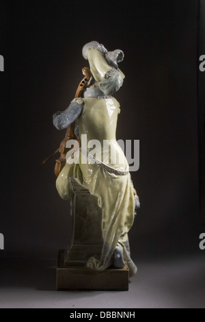 This painting features a woman playing a viola da gamba, a stringed ...