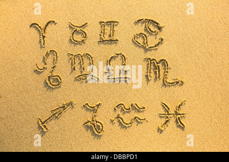 Set of zodiac signs drawn on the facture beach sand Stock Photo - Alamy