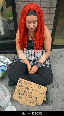 Young teen redhead girl sits on bench in park and takes selfie, makes a ...