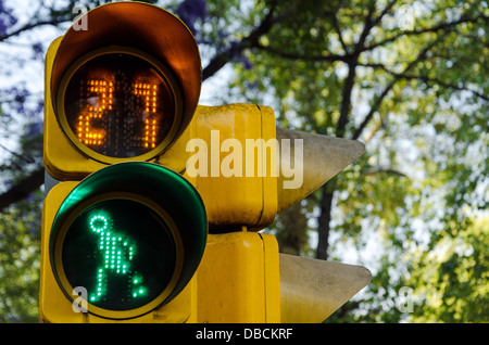 Pedestrian signal light showing green walking man in city centre of ...