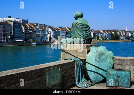 The Helvetia statue in Basel on the Rhine river. The river flows ...