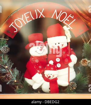 A "Joyeux Noel" French text on a white background with tree and ...