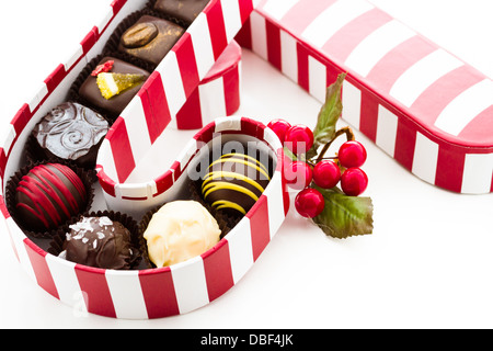 Assorted truffles in candy cane box on a white background Stock Photo ...