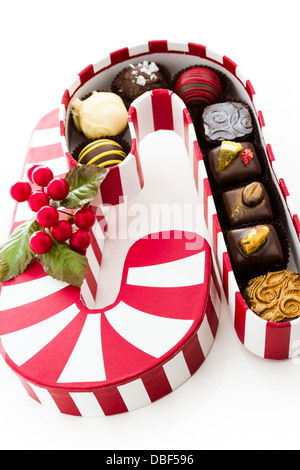 Assorted truffles in candy cane box on a white background Stock Photo ...