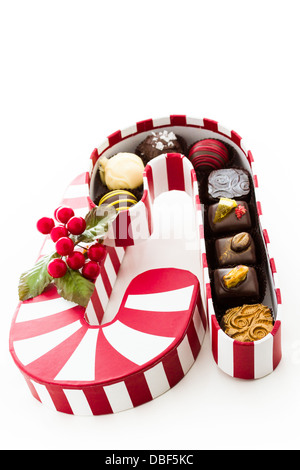 Assorted truffles in candy cane box on a white background Stock Photo ...