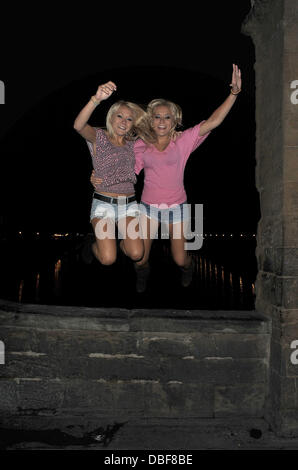 Twins Brittany Taltos (in pink) and her sister Erica Taltos enjoy a ...
