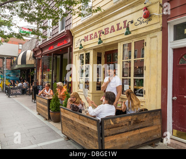 USA, New York City, Brooklyn, woman picking up jigsaw pieces from ...