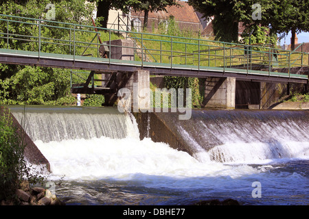 a dam retaining water from a swollen river with its bridge and ...