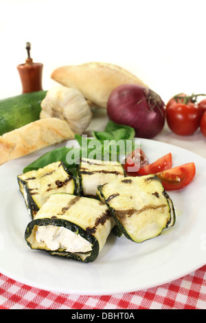 stuffed courgette rolls and tomatoes on a white plate Stock Photo - Alamy