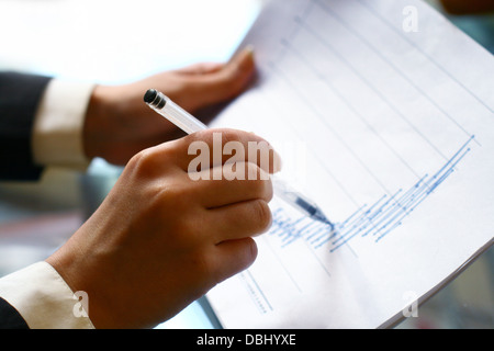 read the graph in financial report Stock Photo - Alamy